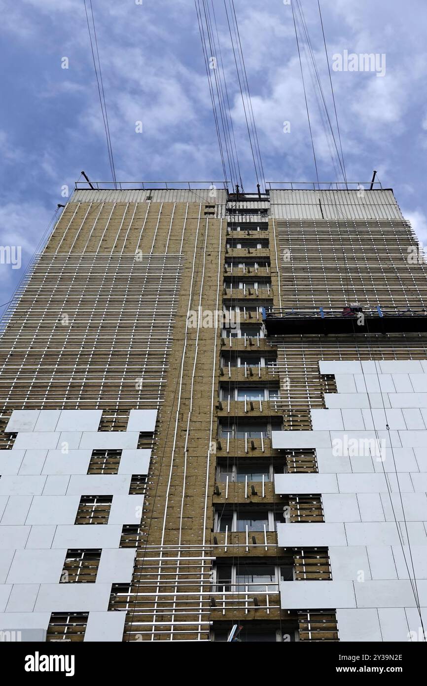 Bottom up view of being renovate high building with insulation on ...