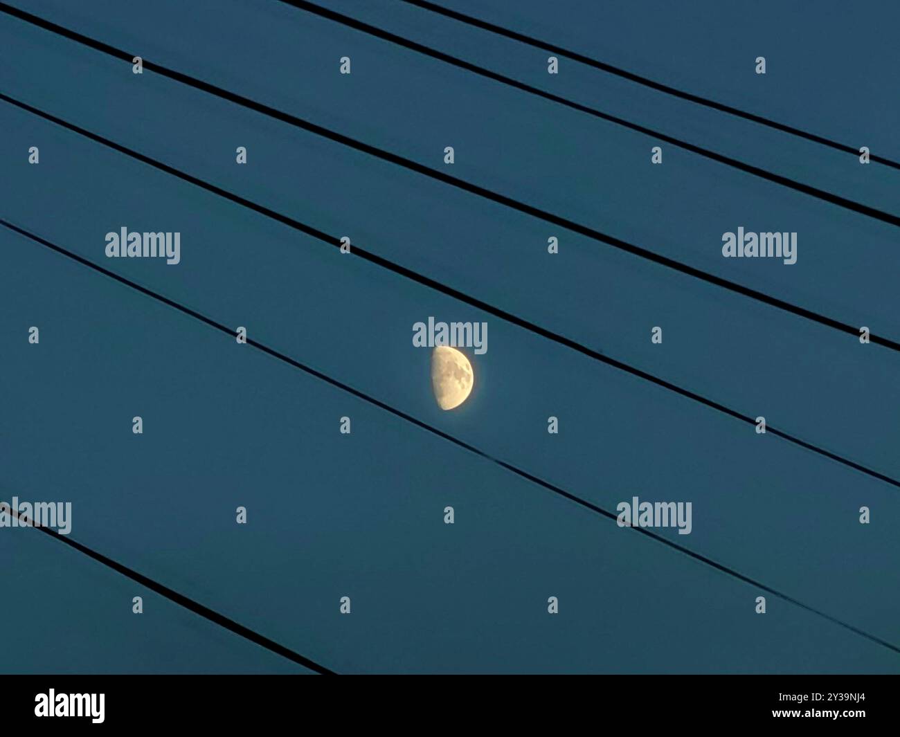 Framed Half Moon by Electricity Cables: A Nighttime Sky Composition ...