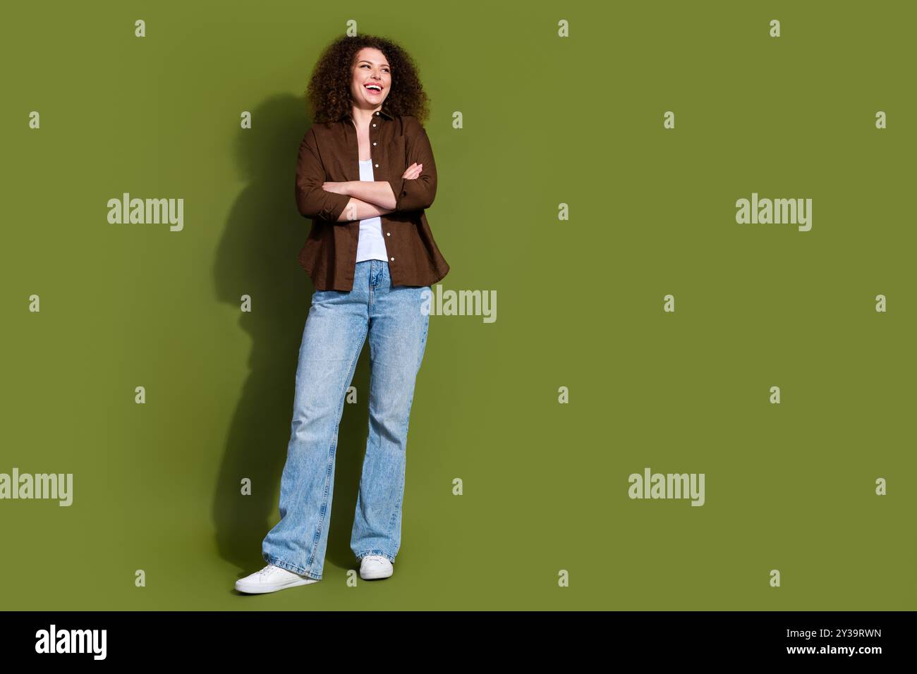 Full body portrait of nice young girl folded arms look empty space ...