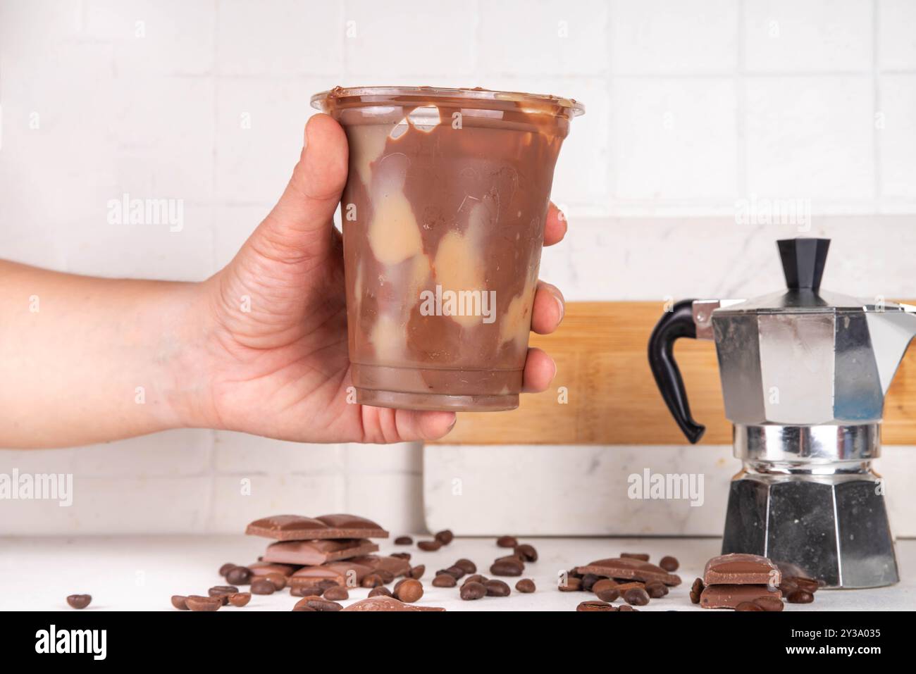 Viral Cracking Chocolate Latte drink. Plastic glass with cracked milk ...
