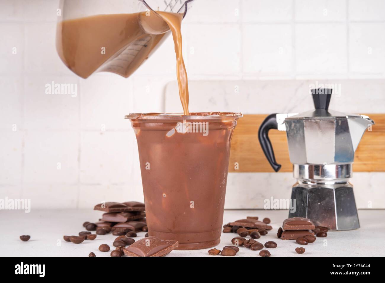 Viral Cracking Chocolate Latte drink. Plastic glass with cracked milk ...
