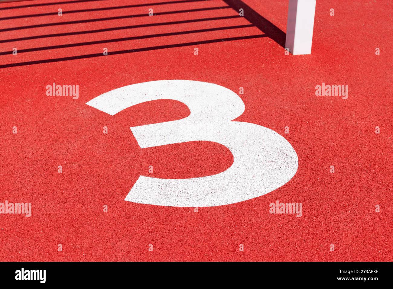 The number 3 on a sports floor. White on red. 3rd place / bronze medal ...