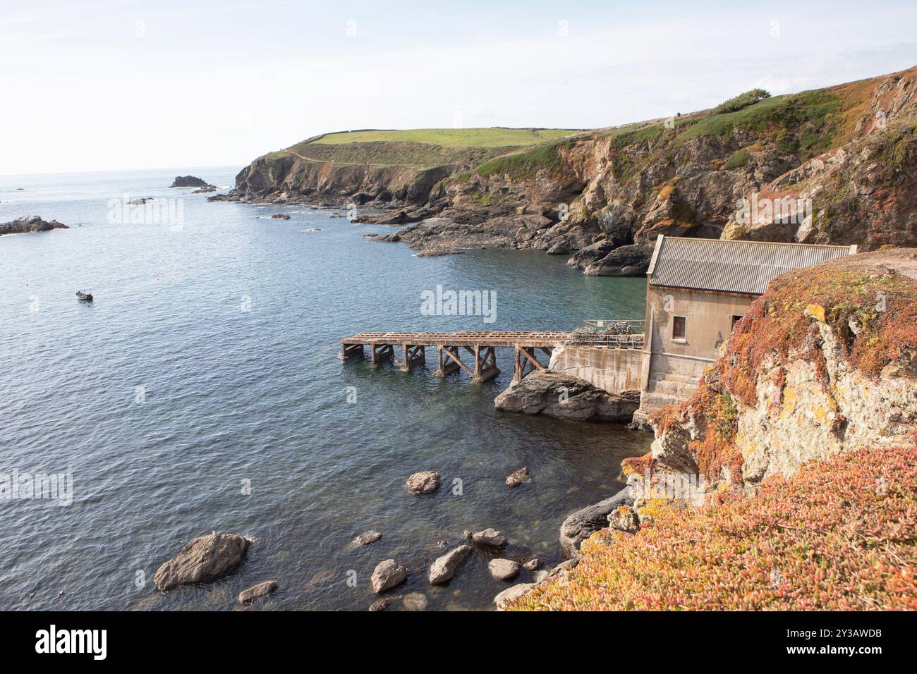 An abandoned pier and boathouse sits along the steep cliffs at Lizard's ...