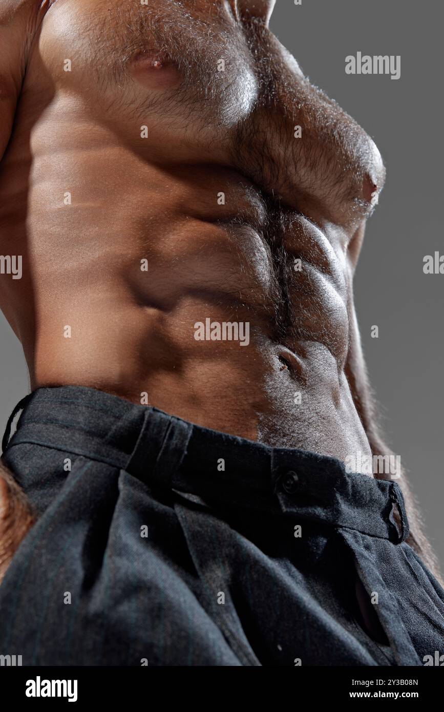 Close-up shot emphasizes muscular chest and abs of man, veins visible ...