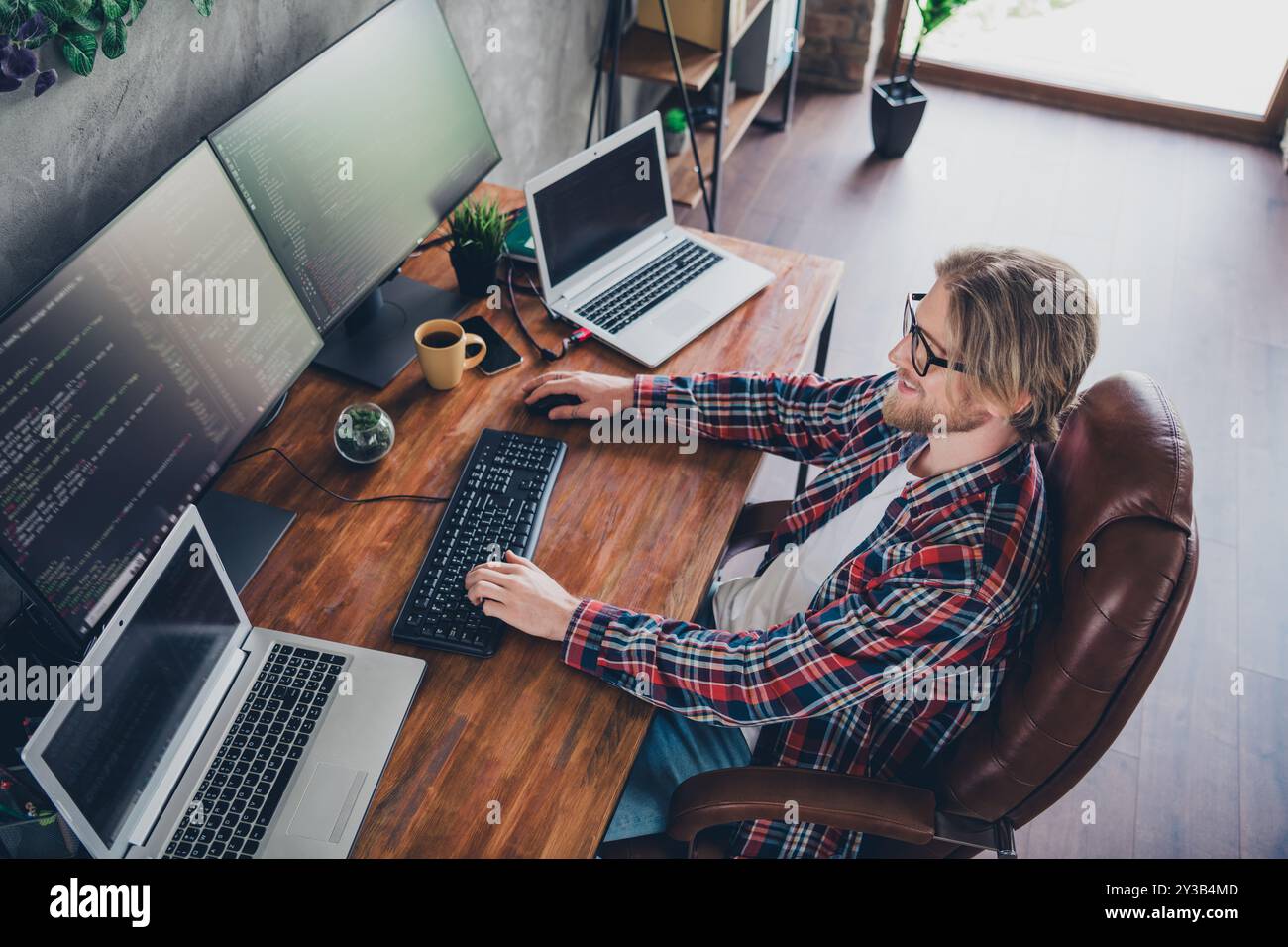 Top view photo of blond hair geek software developer sitting leather ...