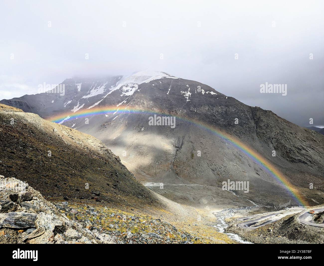 rainbow in mountain range Stock Photo - Alamy