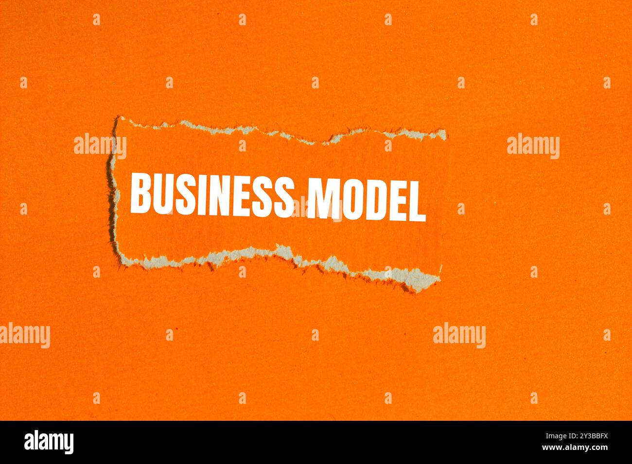Business model message written on ripped torn orange paper with orange background. Conceptual ...