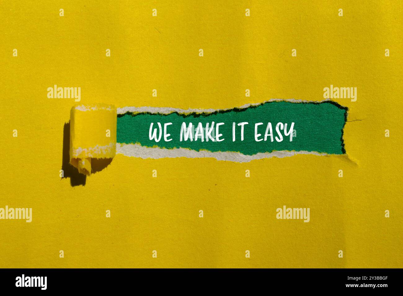 We make it easy message written on ripped yellow paper with green ...