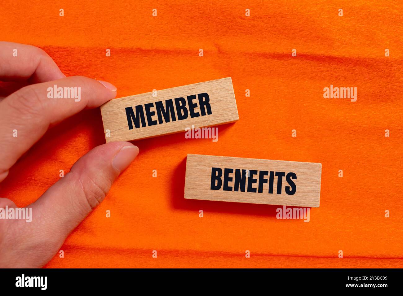 Member benefits message written on wooden blocks with orange background ...