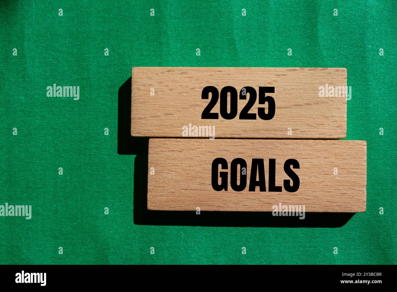 2025 goals message written on wooden blocks with green background ...