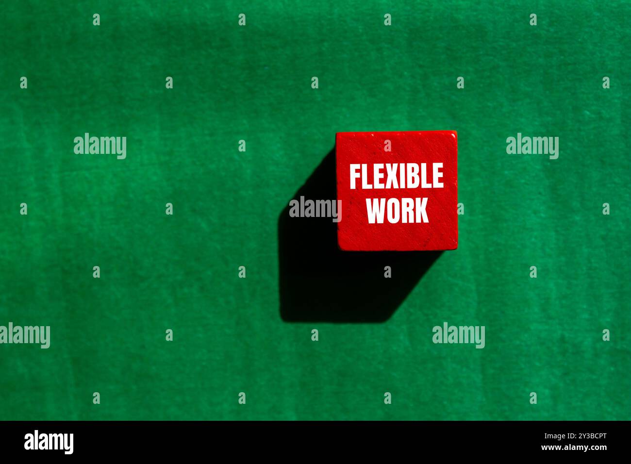 Flexible work message written on red wooden cube with green background ...