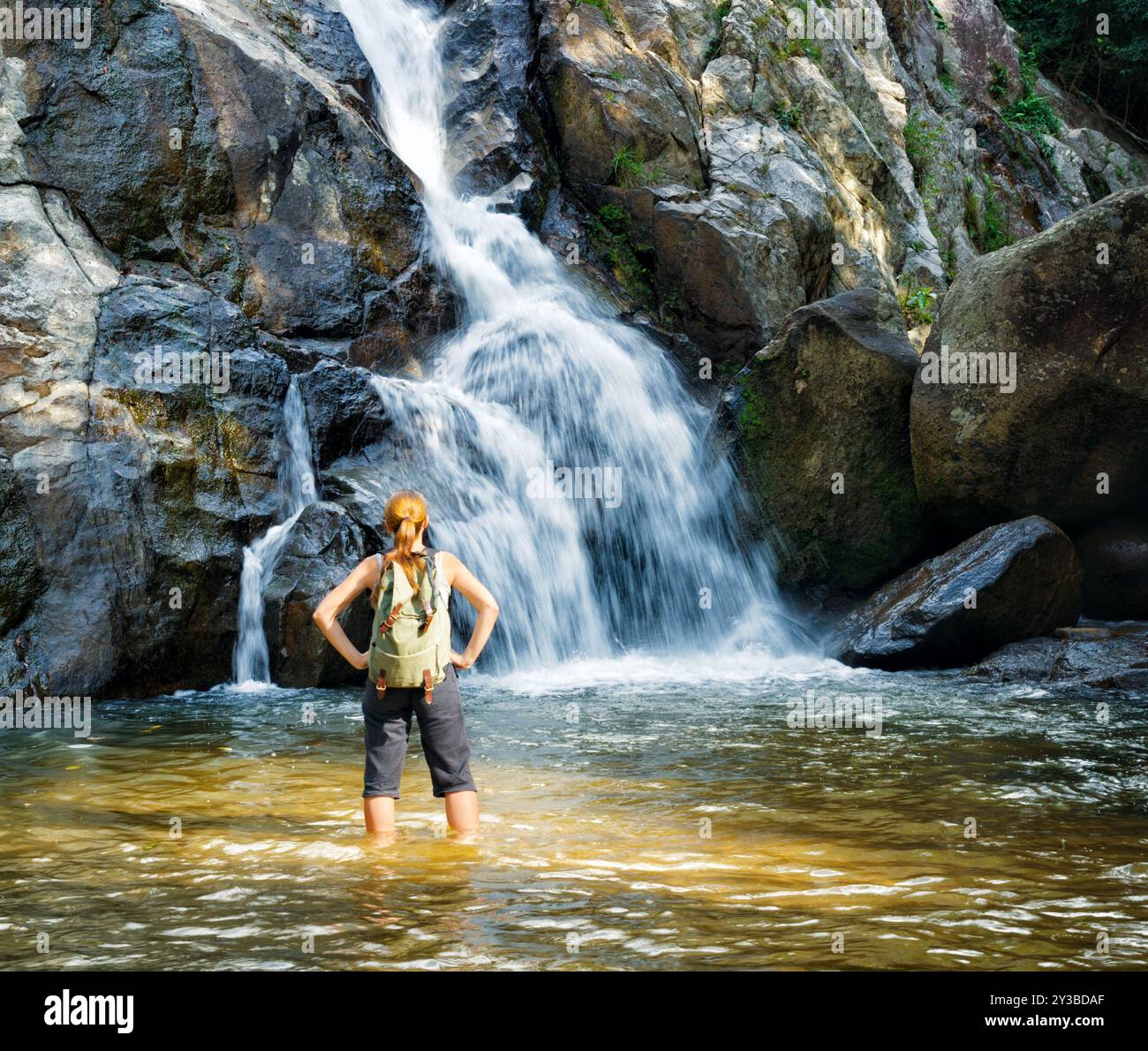 Female hiker looking at waterfall Stock Photo - Alamy