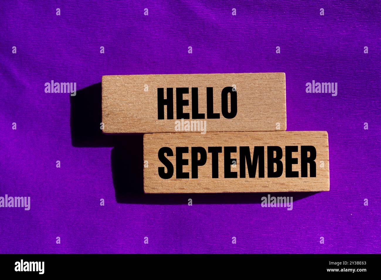 Hello september message written on wooden blocks with purple background ...