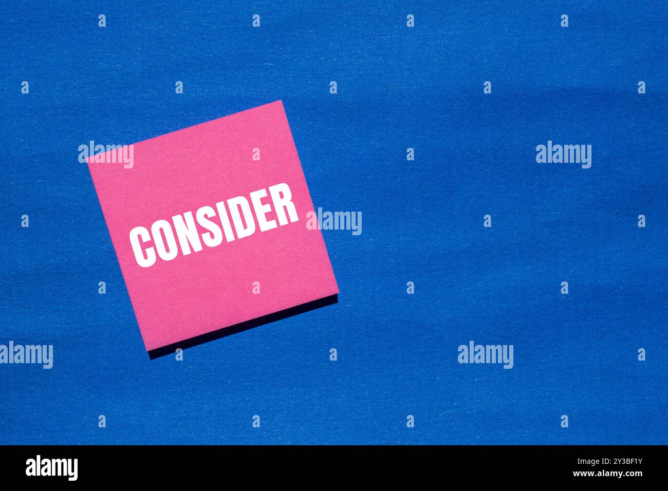 Consider message written on pink paper with blue background. Conceptual ...