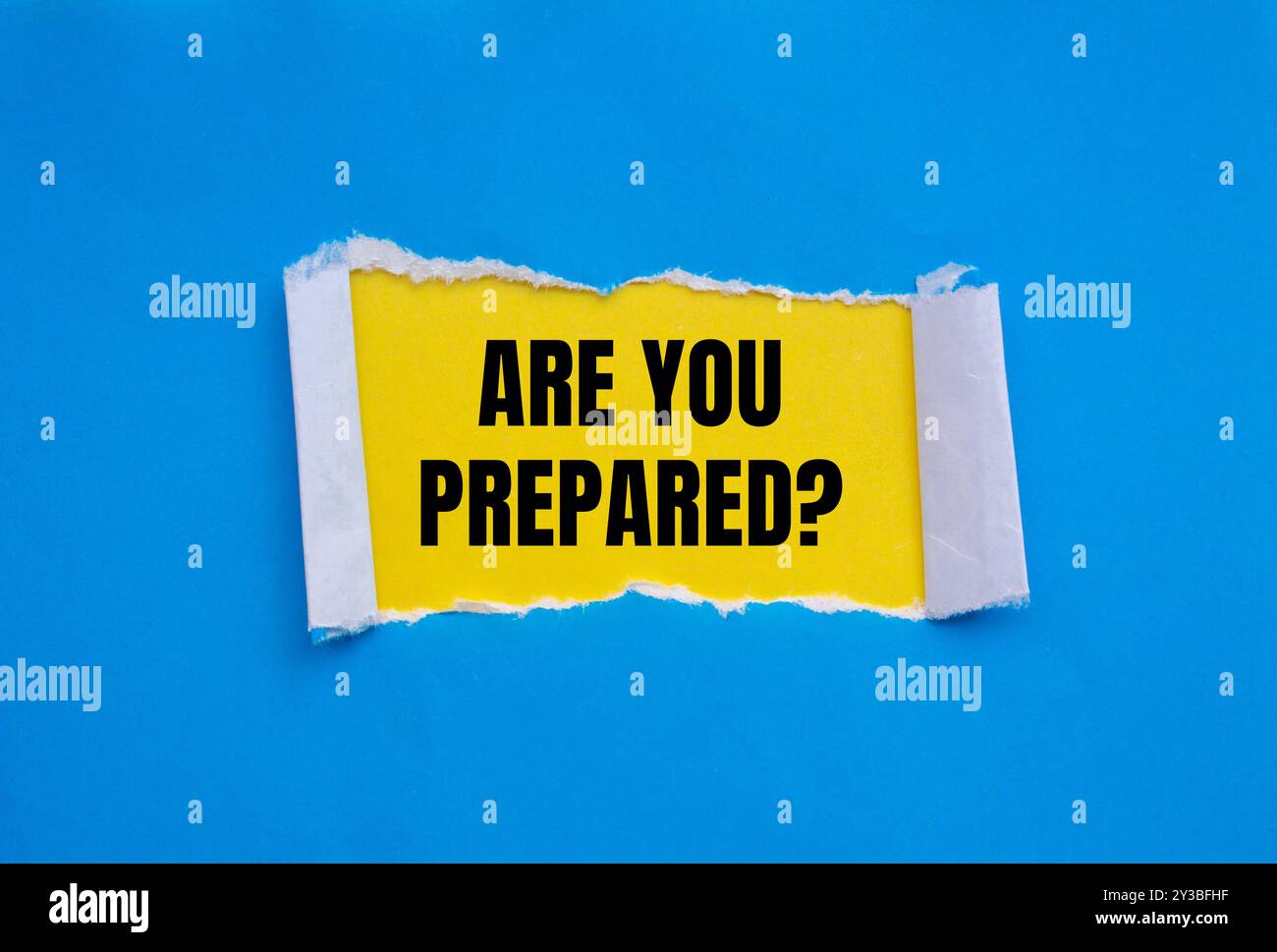 Are you prepared question written on ripped torn blue paper with yellow ...