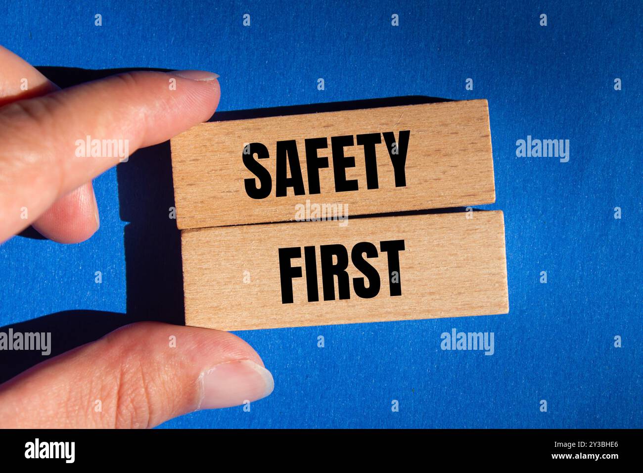 Safety first message written on wooden blocks with blue background ...