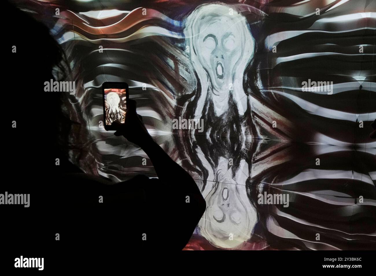 Visitors watch an immersive video during a press preview of the Edvard ...