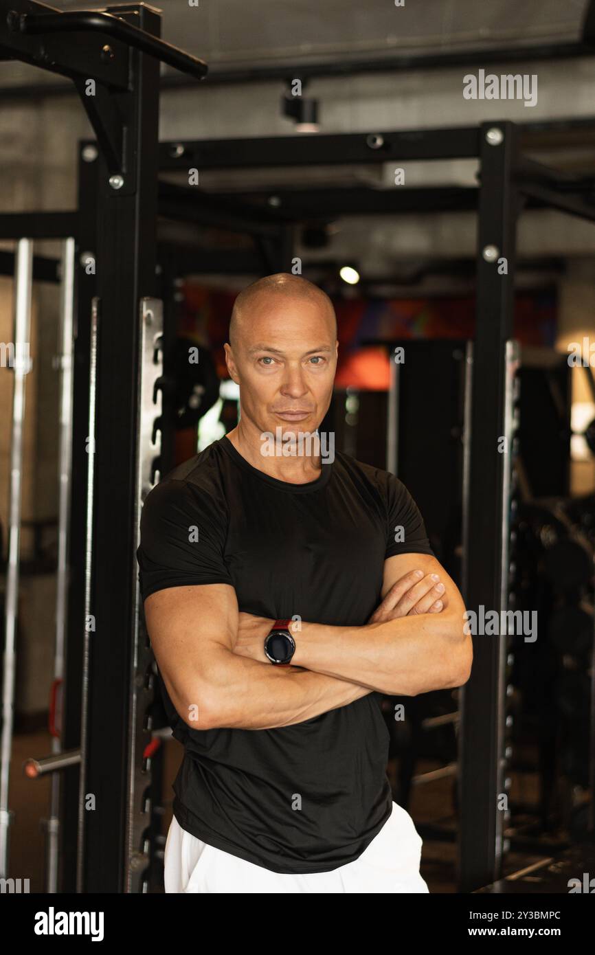 Bald handsome sportsman wearing black hi-res stock photography and ...
