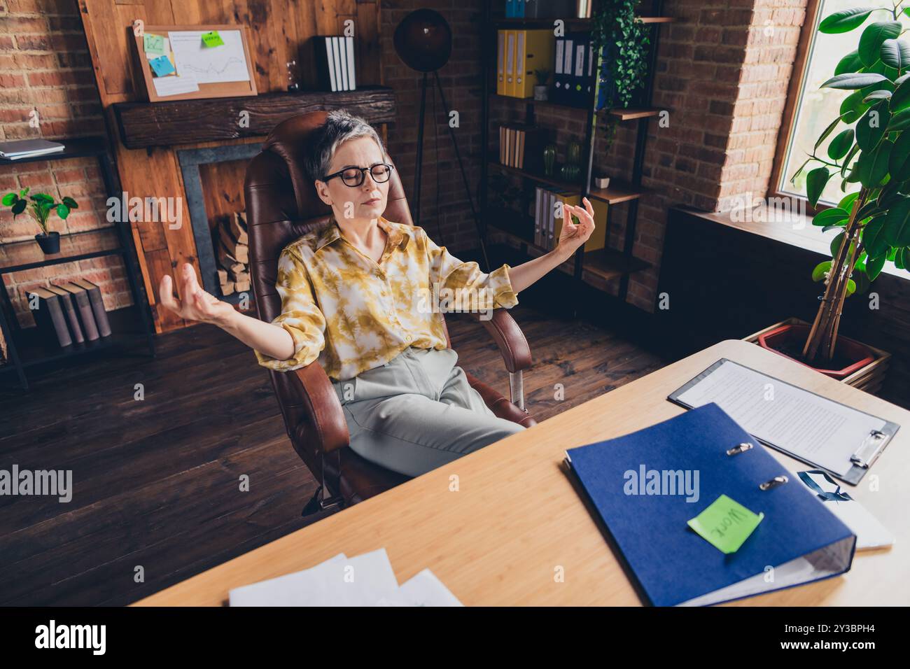 Photo of calm relaxed senior woman sitting armchair relax rest yoga om ...