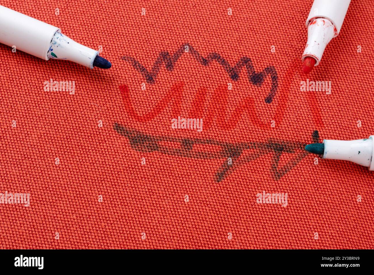 Creative drawing felt-tip pens on the light green upholstered furniture ...