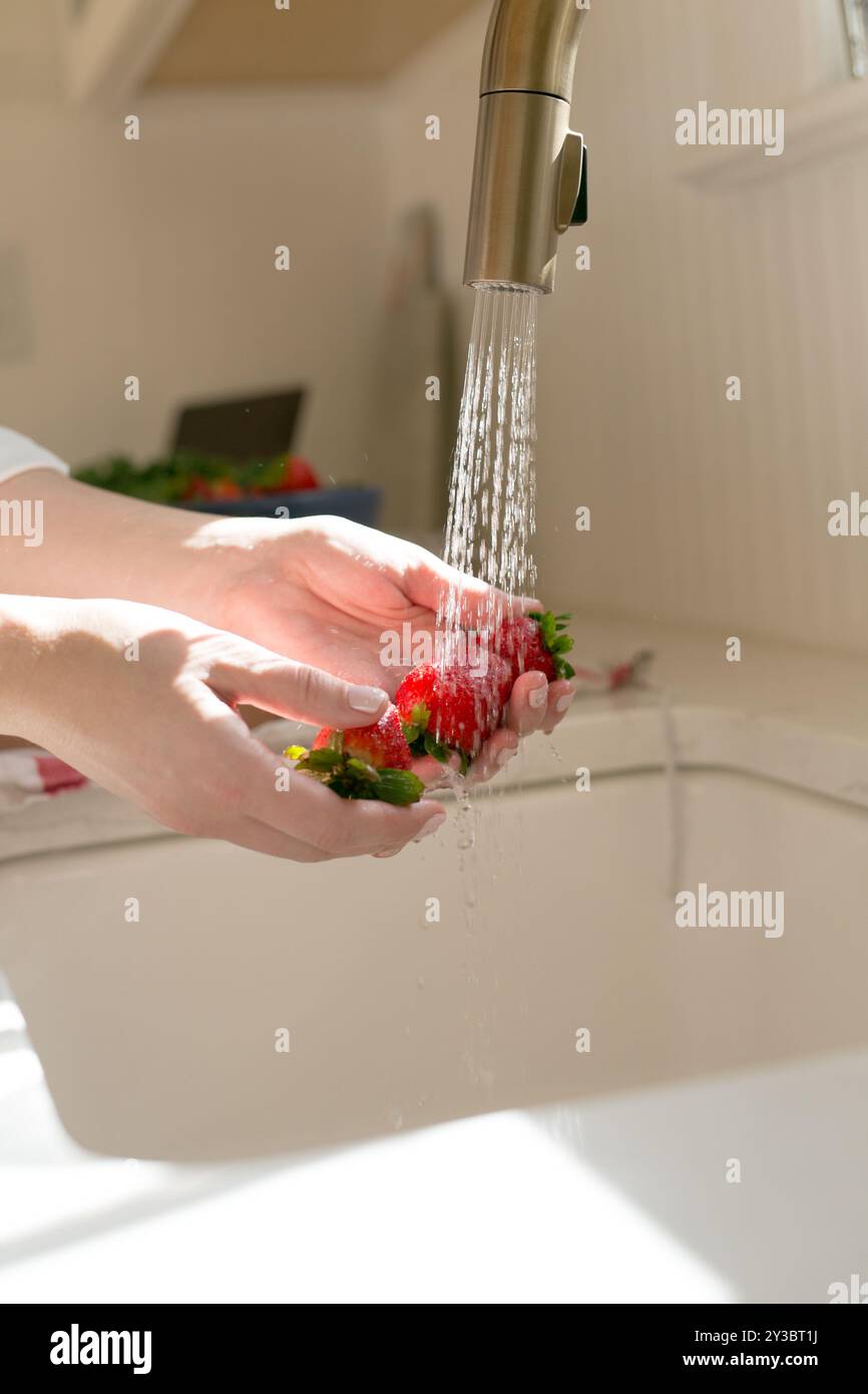 Hands washing fruit in kitchen hi-res stock photography and images - Alamy