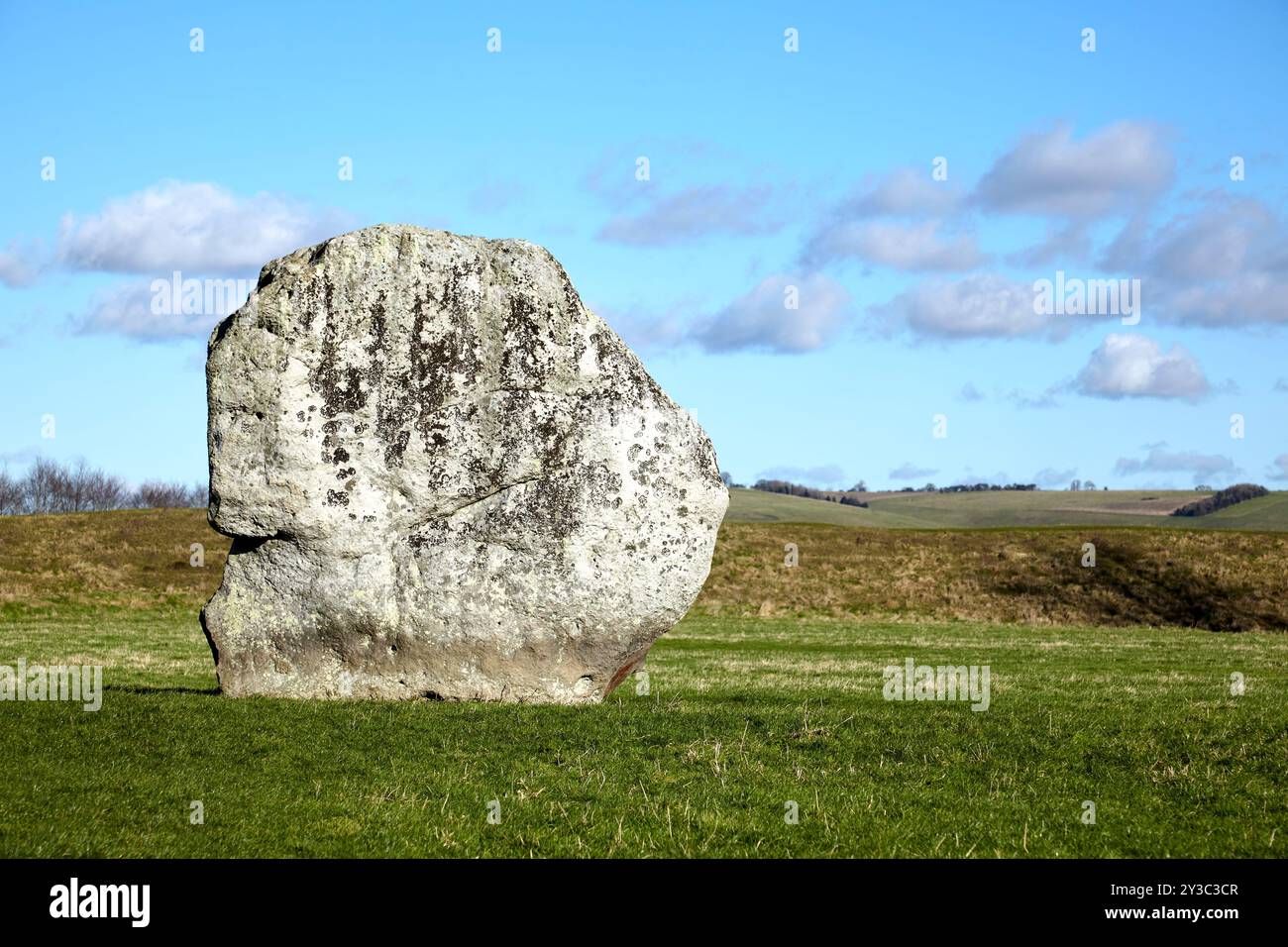 Ancient standing stone in Avebury, England, under a clear blue sky. The ...