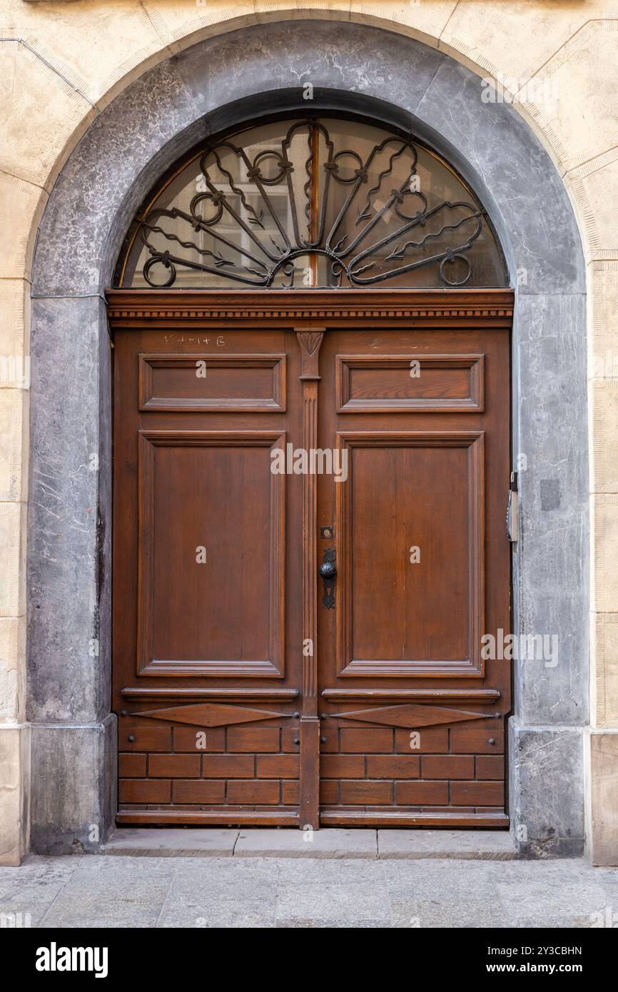 Elegant wooden door with ornate glass design in a historical building ...