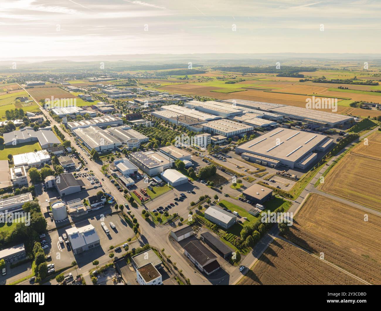 A large industrial area with factories, roads and surrounding fields in ...