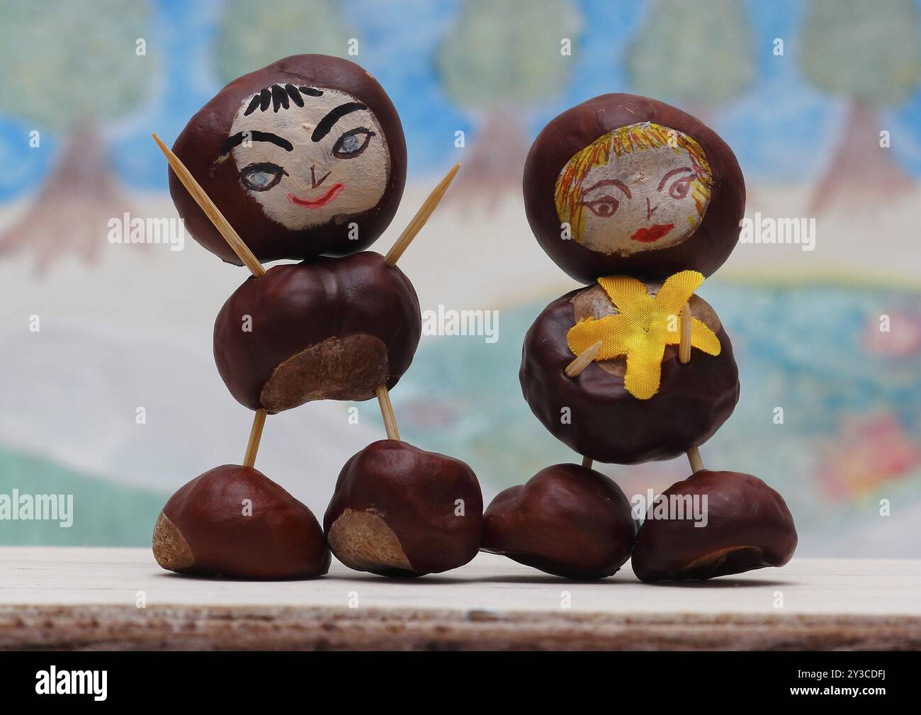 Two cute chestnut figures in front of a painted background, North Rhine ...