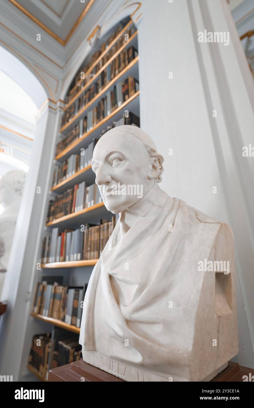 Bust of a historical scholar in front of a bookshelf in an impressive ...