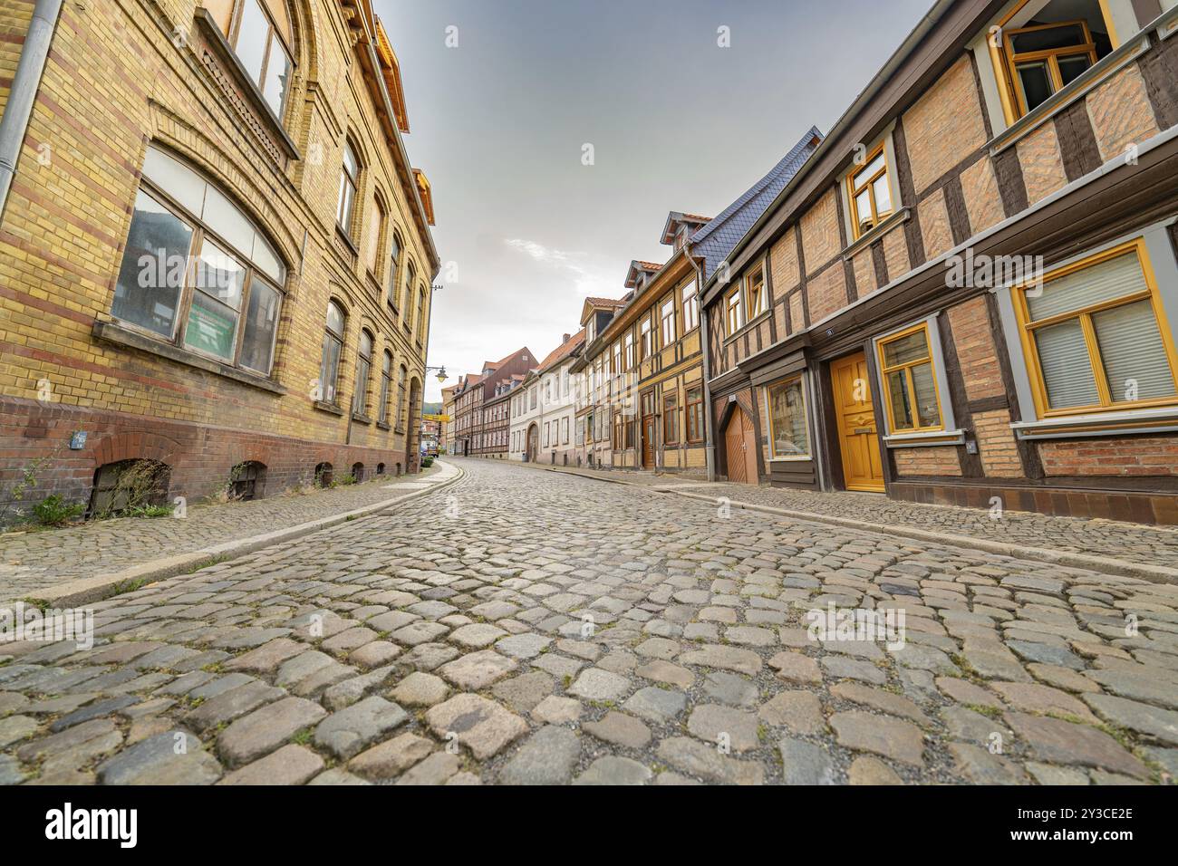 Historic town street with half-timbered houses and a narrow cobbled ...