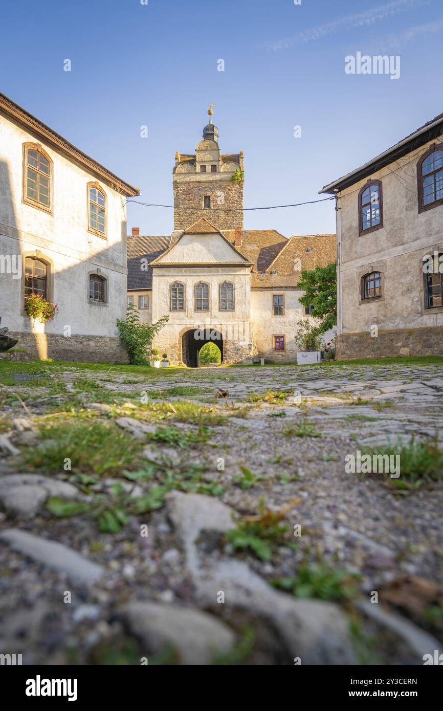 Medieval castle courtyard with stone paths and historic buildings in ...