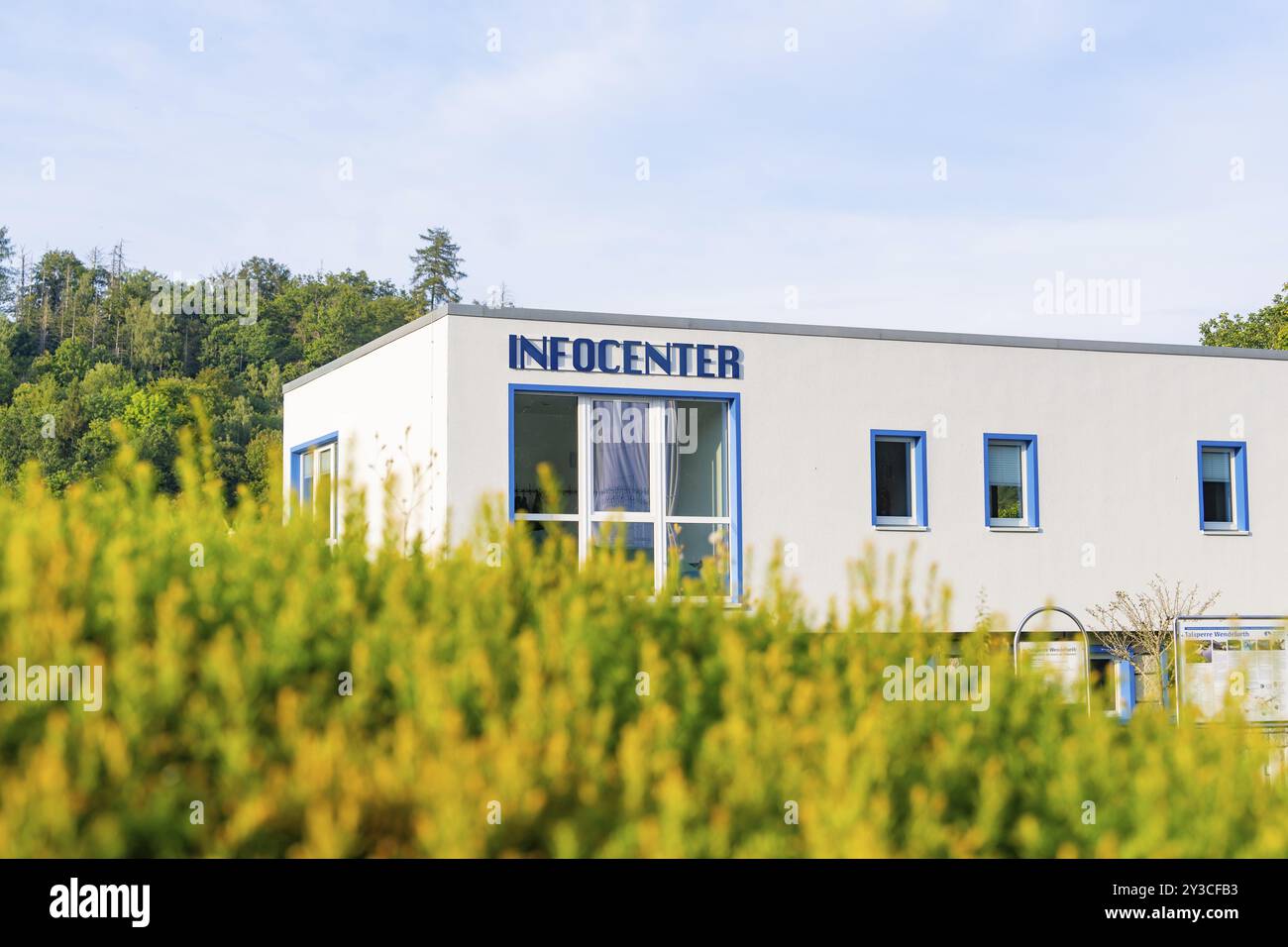 Modern information centre building with large glass windows, surrounded ...