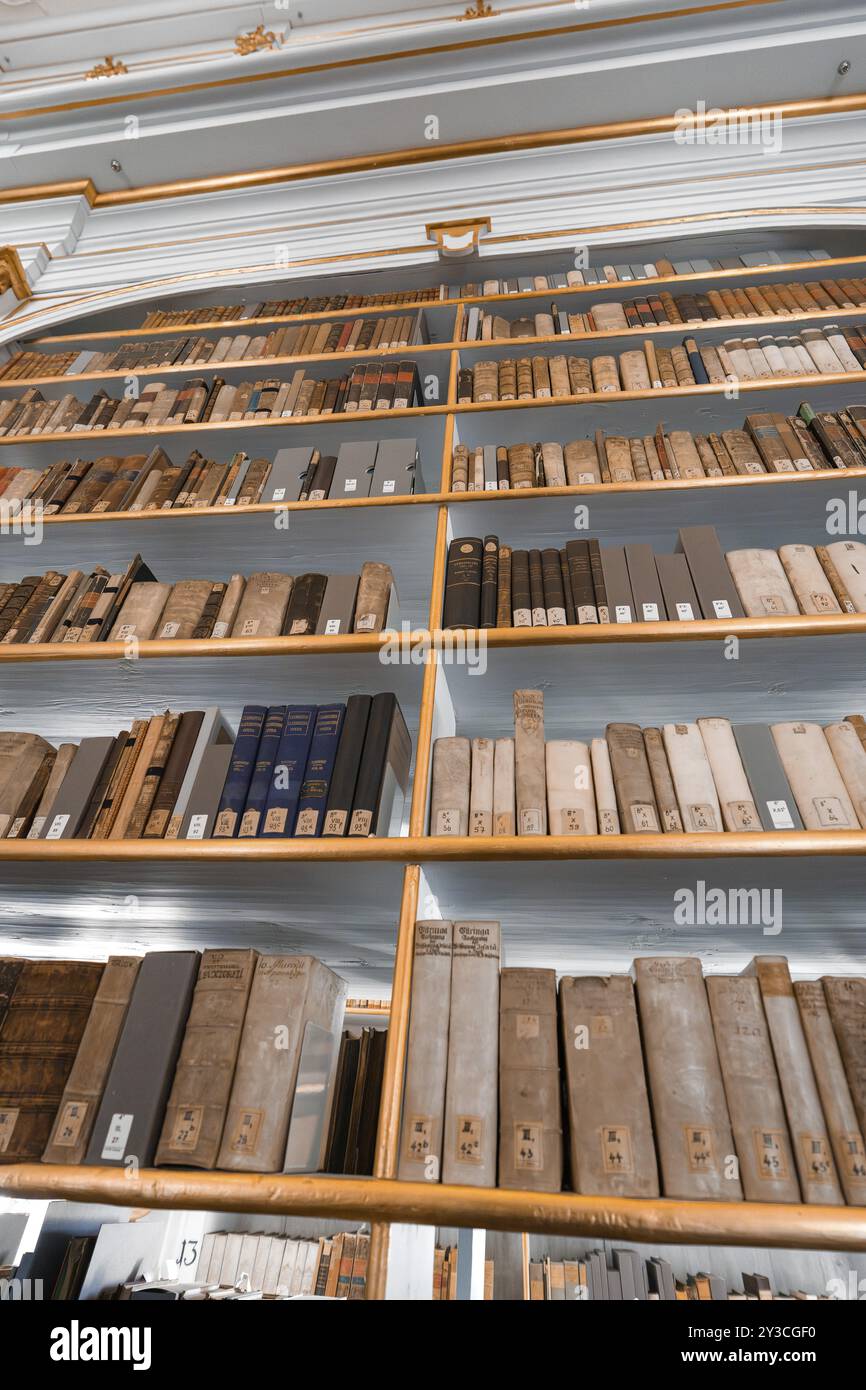 Bottom-up perspective of a tall bookshelf filled with old books, Weimar ...