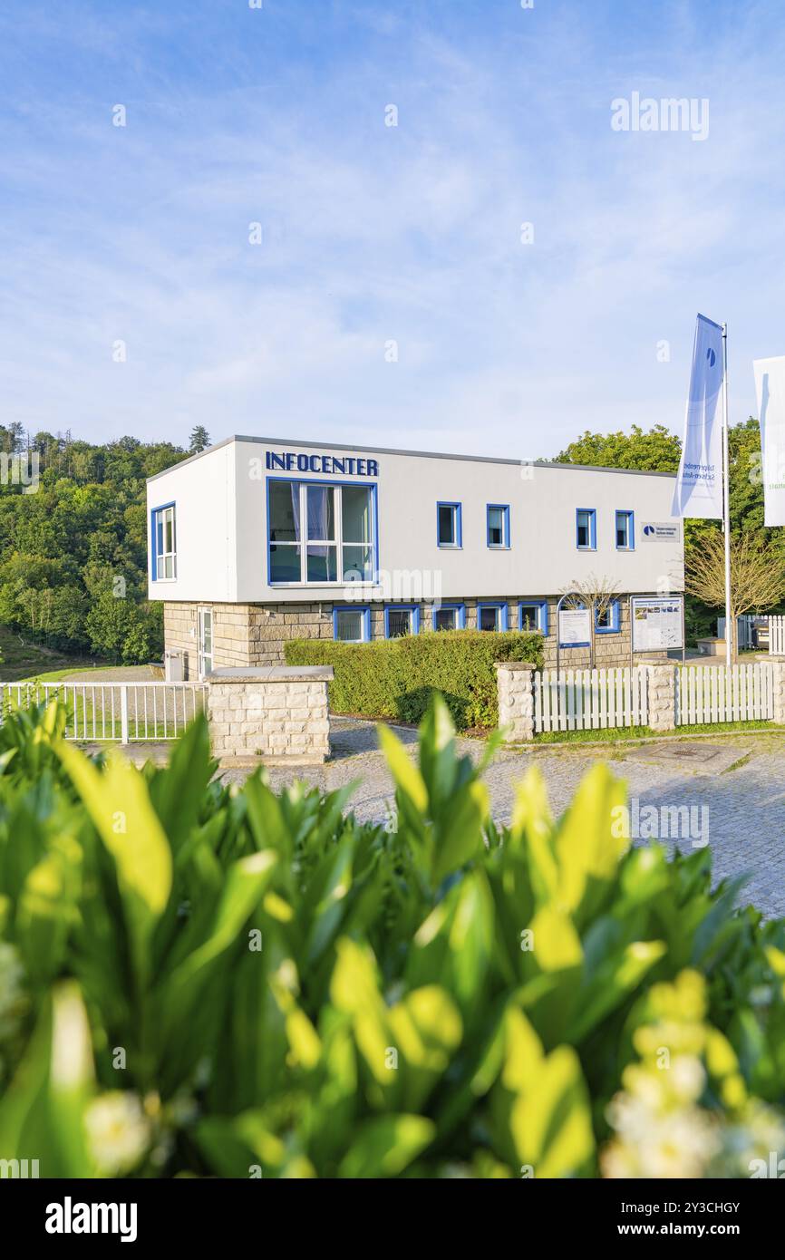 Modern information centre building with large glass windows and fences ...