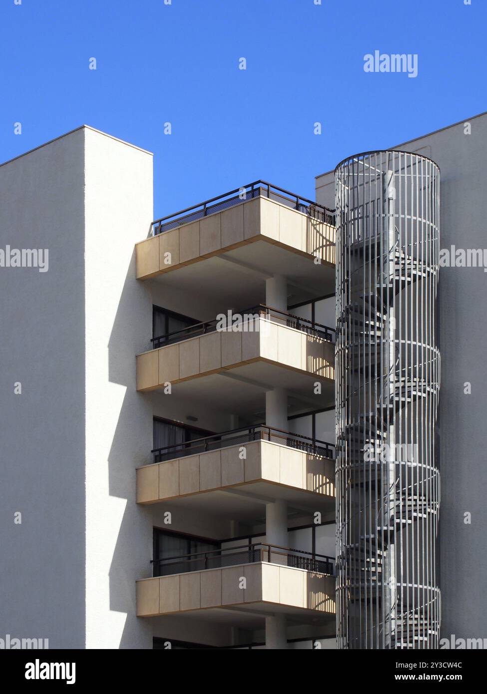 Modern apartments detail with balconies spiral fire escape and white ...