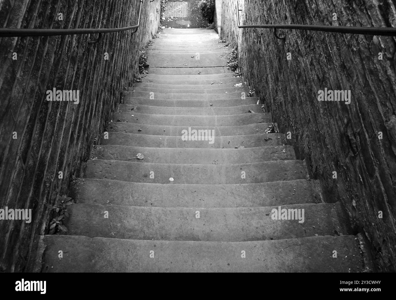 A monochrome perspective view of narrow old outdoor stone steps ...