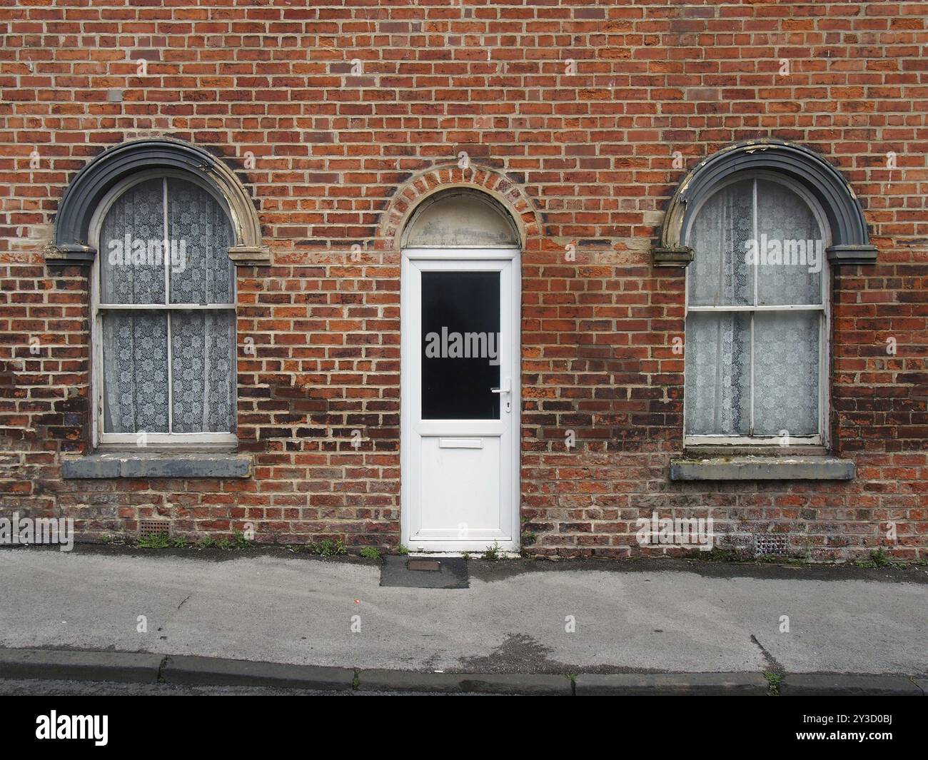White front door and windows of a typical old brick british terraced ...