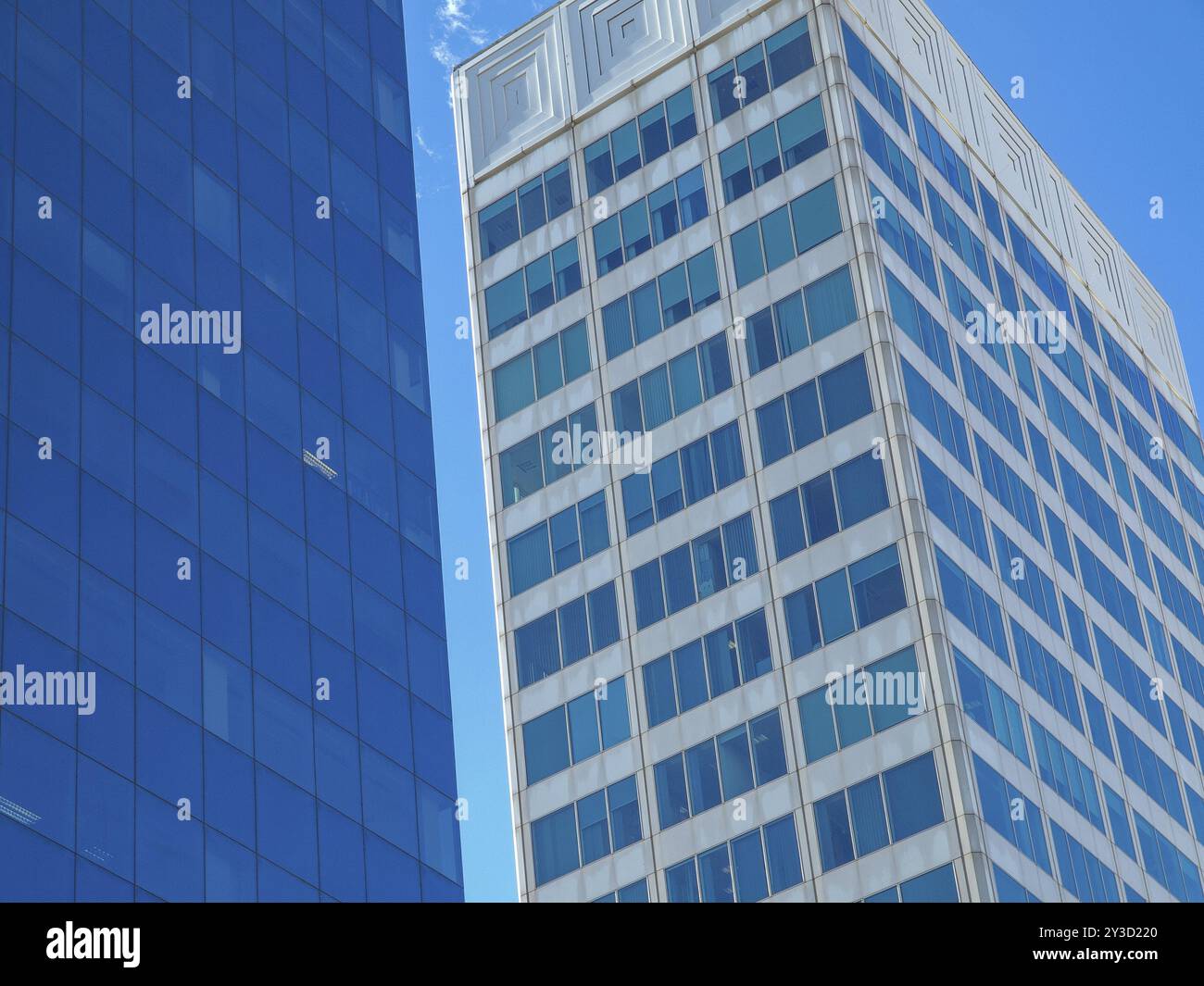 Two skyscrapers with glass facades in front of a blue sky, barcelona ...