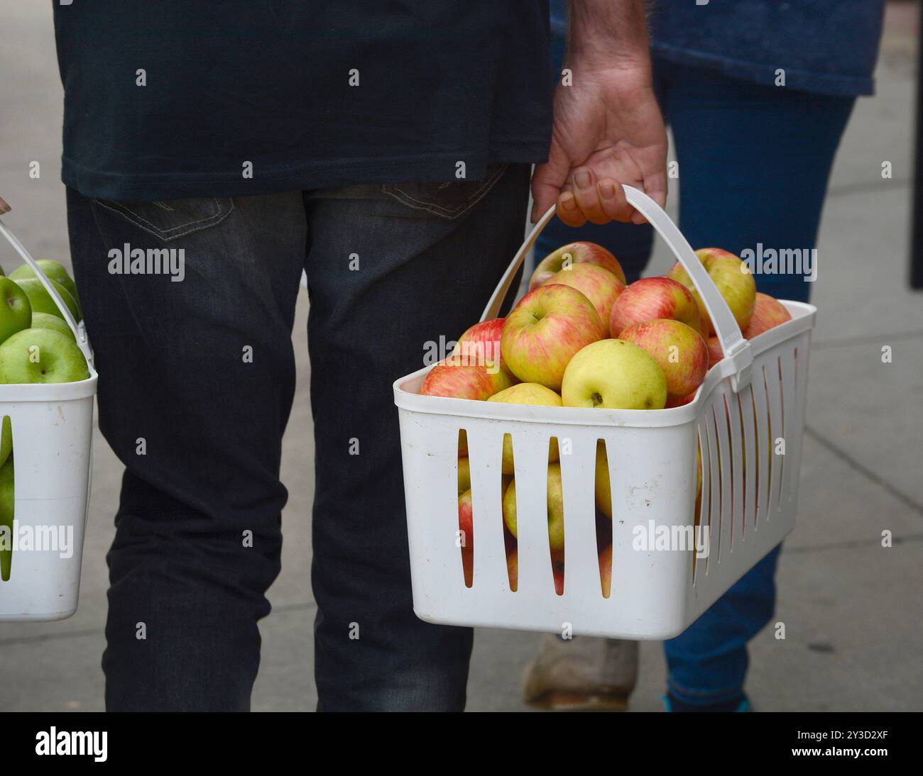 A festival visitor walks with his purhase of apples at the annual fall ...