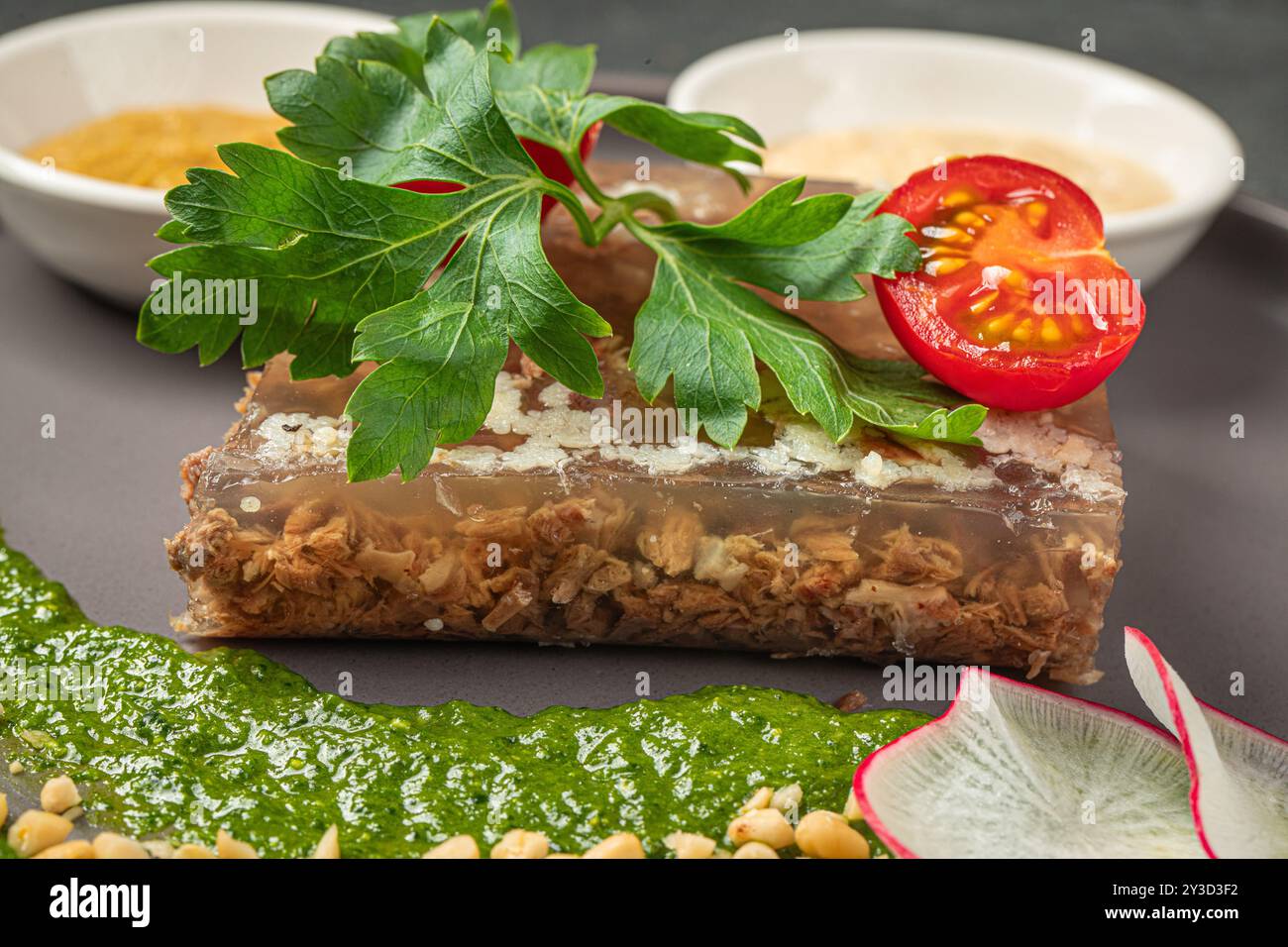 Russian meat jelly dish kholodetz with sauces Stock Photo - Alamy