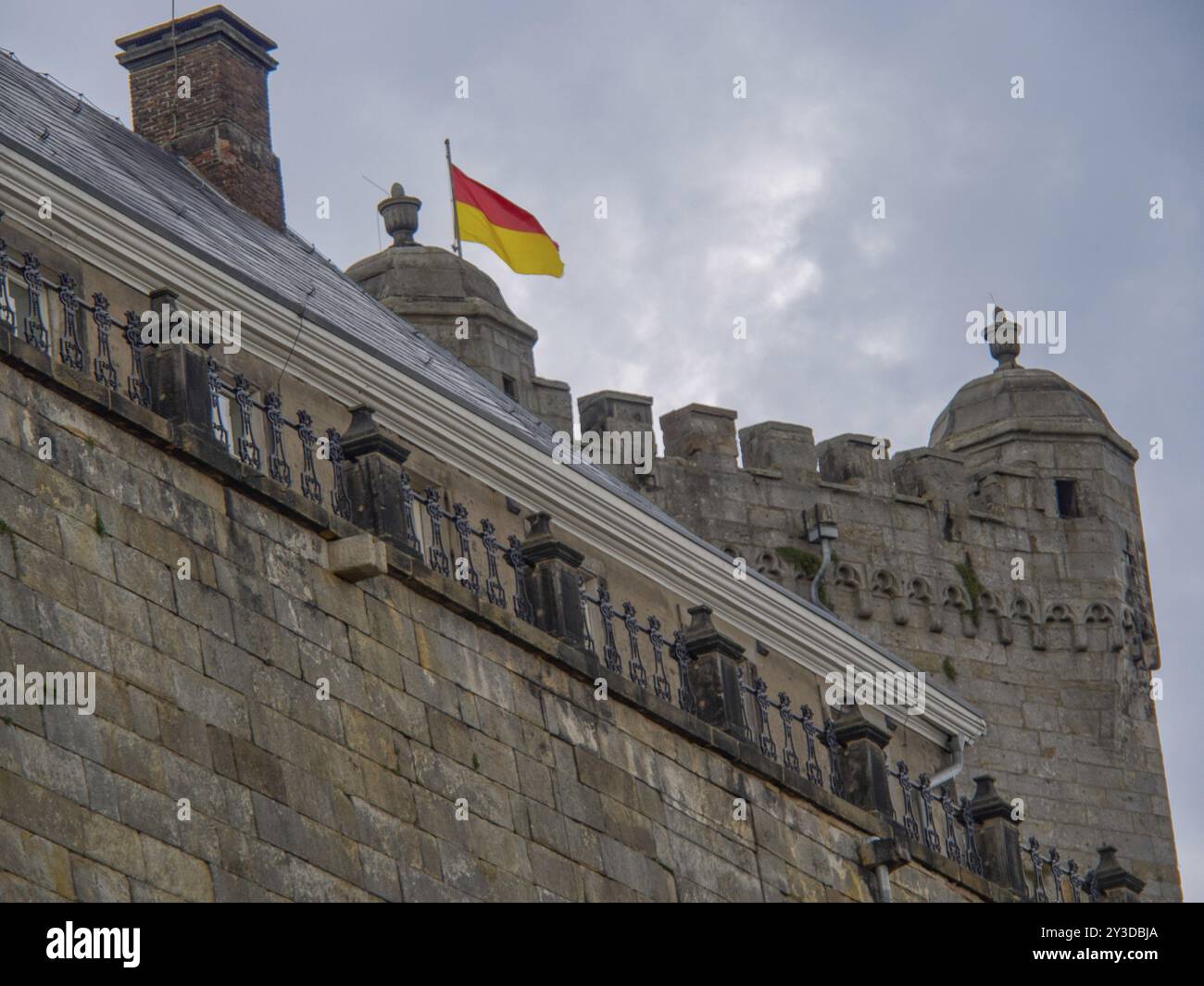 Medieval castle with German flag on the battlements, stone walls and ...
