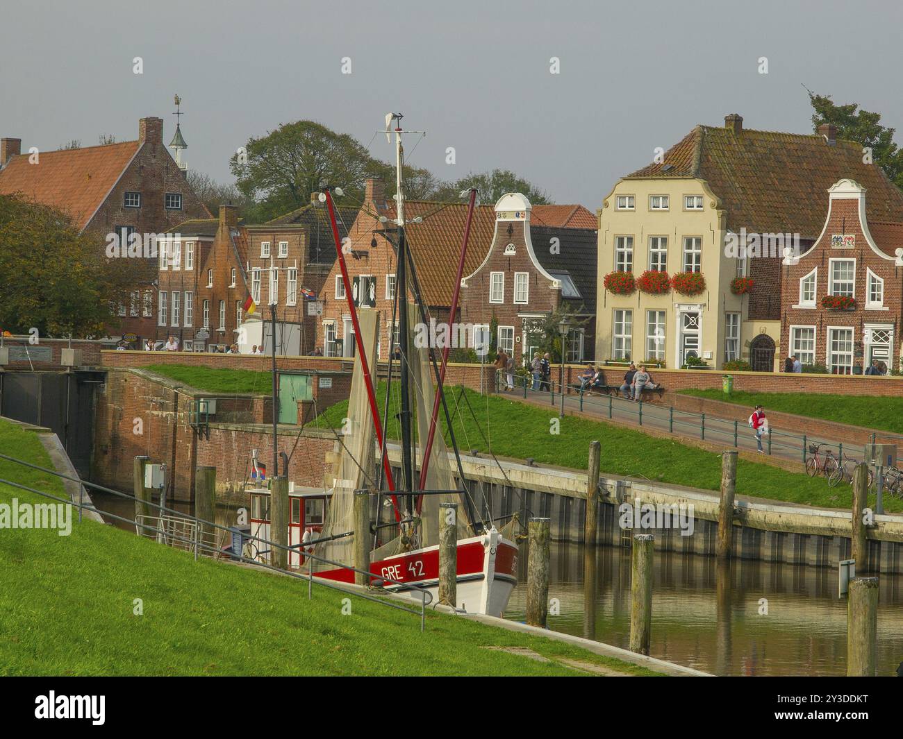 A picturesque harbour with sailing boats in front of historic brick ...
