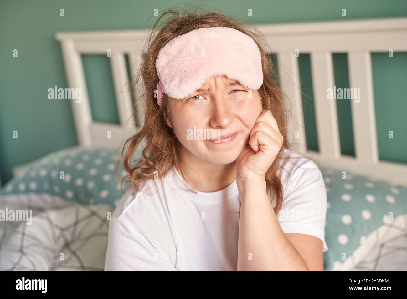 Woman with sleep mask feeling tired in bed - morning routine and self ...
