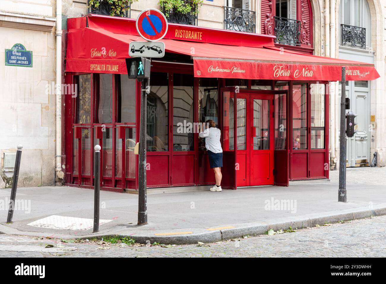 A woman looks through the window of "Terra Nera," a famous filming ...