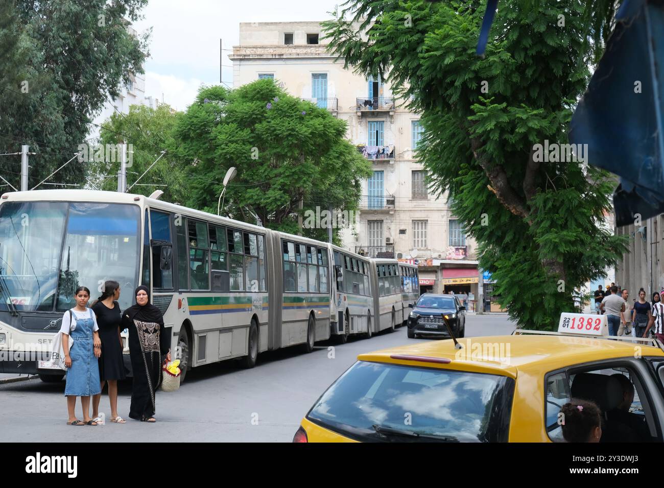 Tunisian family walk in Barcelona Square, a public transportation hub ...