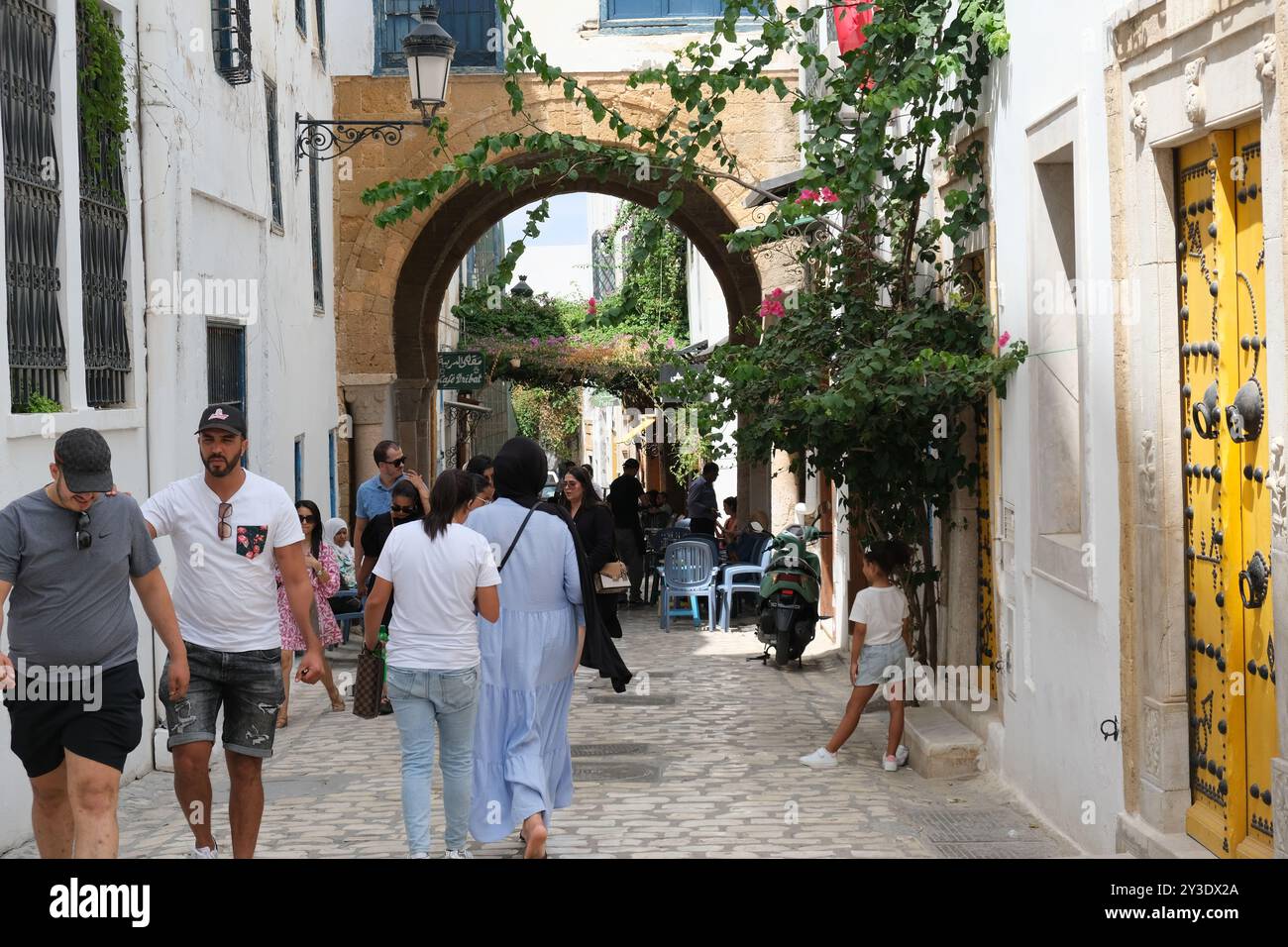 People walk through one of the many archways in Tunis's historic medina ...