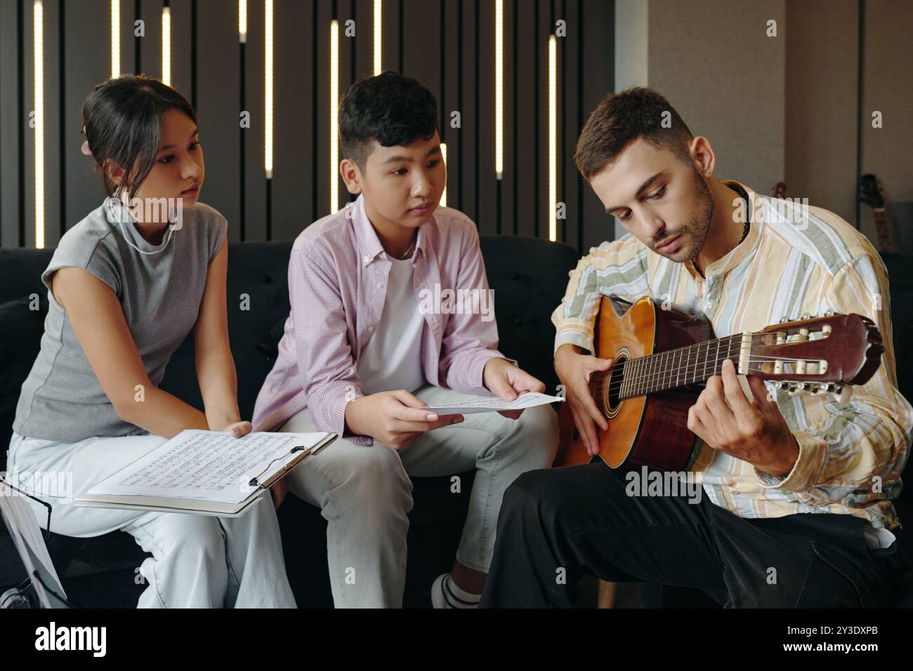 Teaching Guitar to Students Sitting in Classroom Stock Photo - Alamy