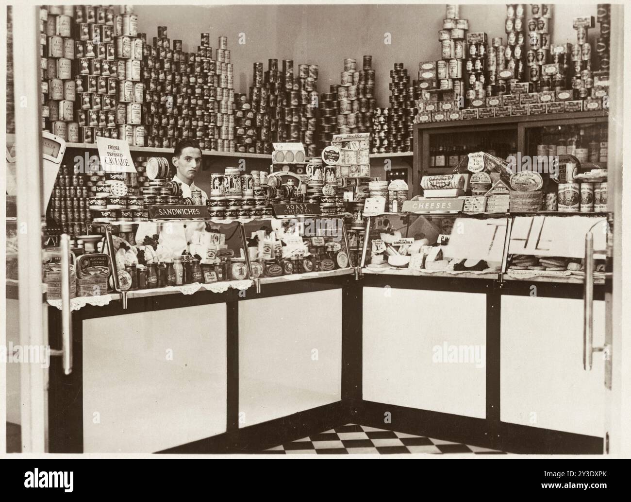 Interior view showing a shop assistant standing behind the sandwich ...