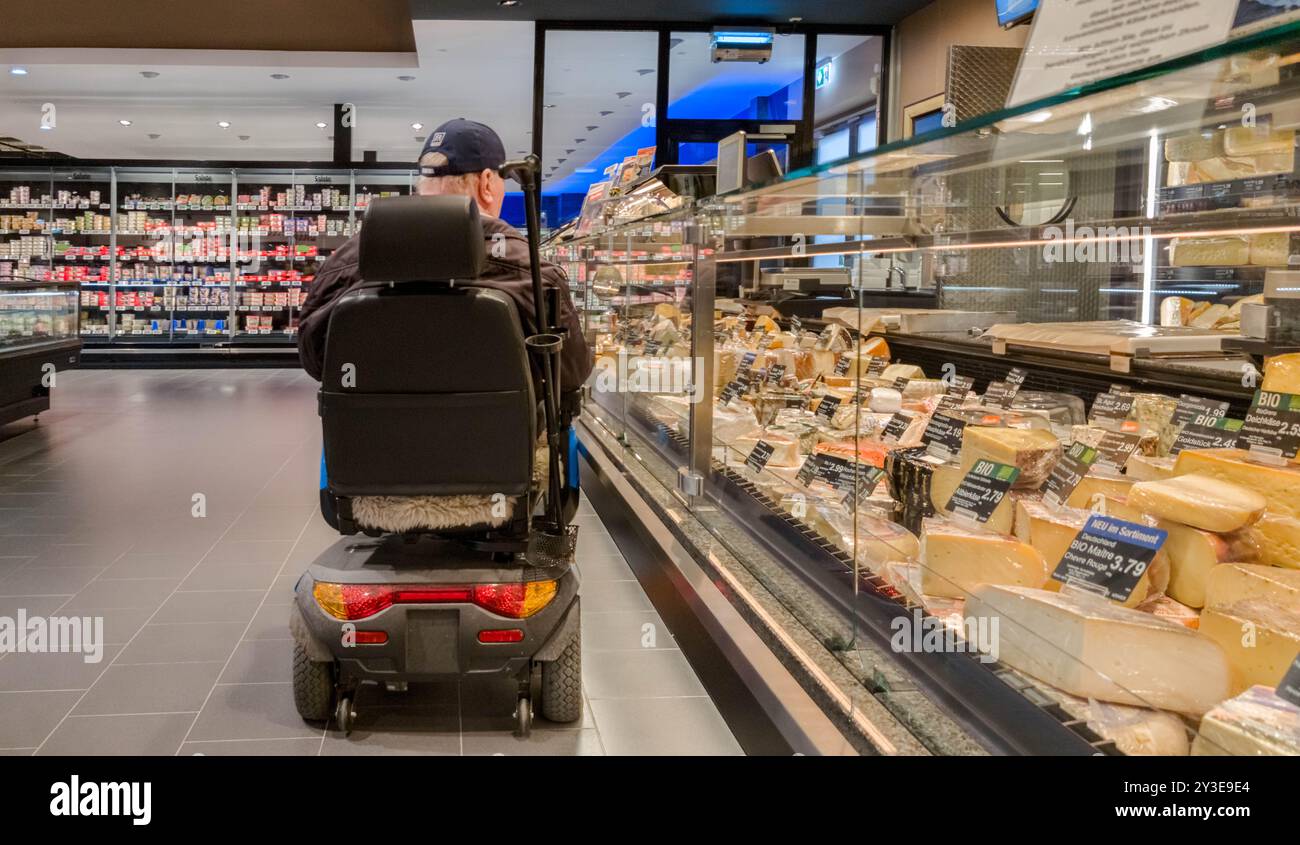 Hamburg, Germany. 10th Aug, 2024. A man in an electric wheelchair looks ...